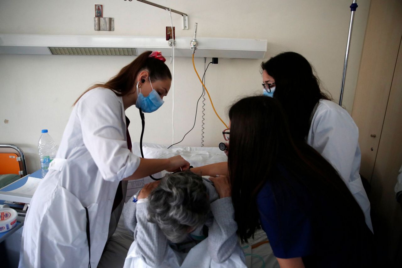 AP PHOTOS: Students help keep Greek COVID hospital on track