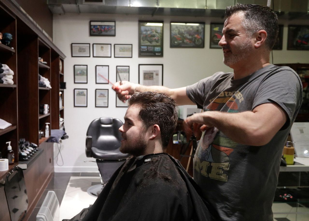 New Zealand barber snips away at midnight as nation reopens