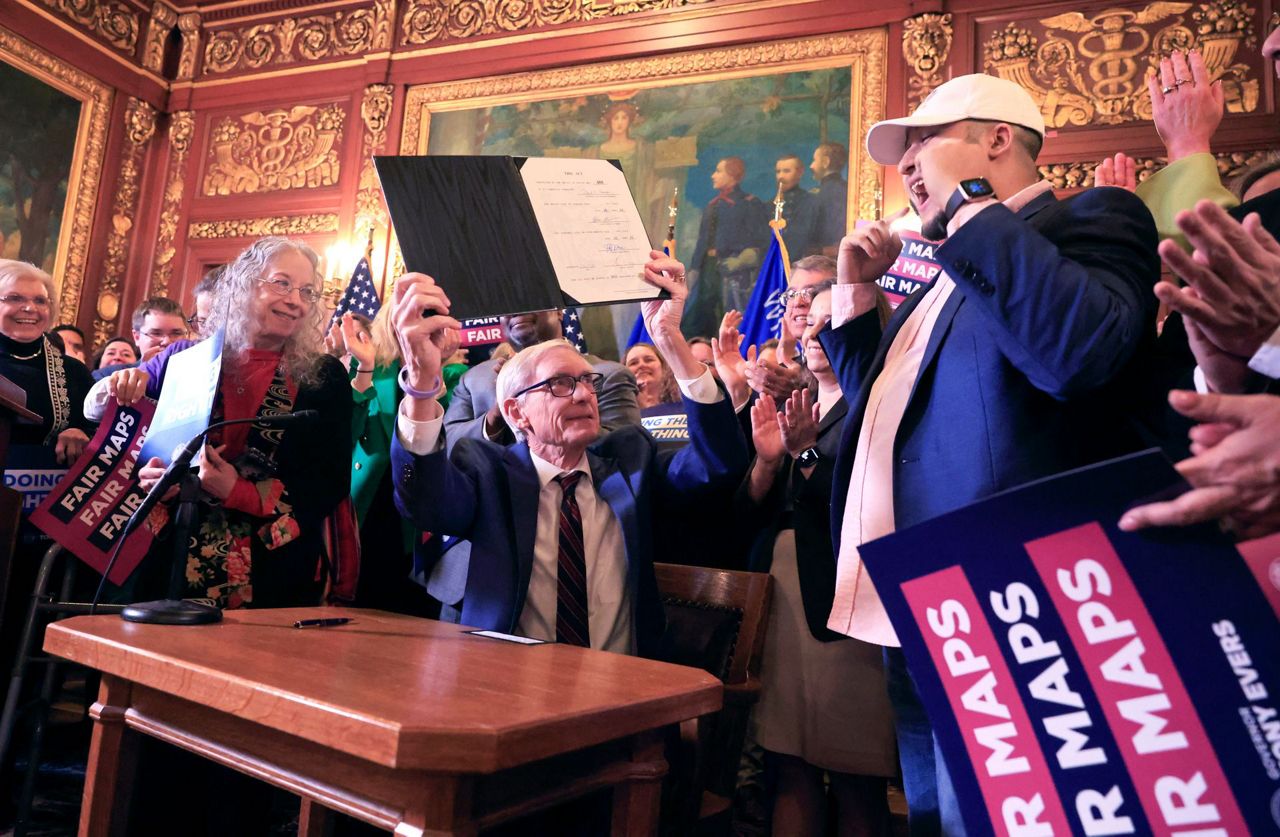 Wisconsin’s Democratic governor signs his new legislative maps into law after Republicans pass them