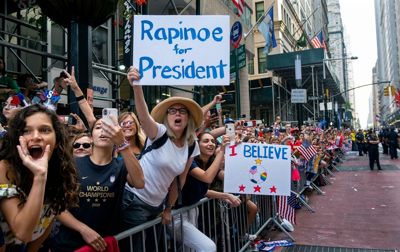The Latest: Crowds chant 'USA!' waiting for soccer parade