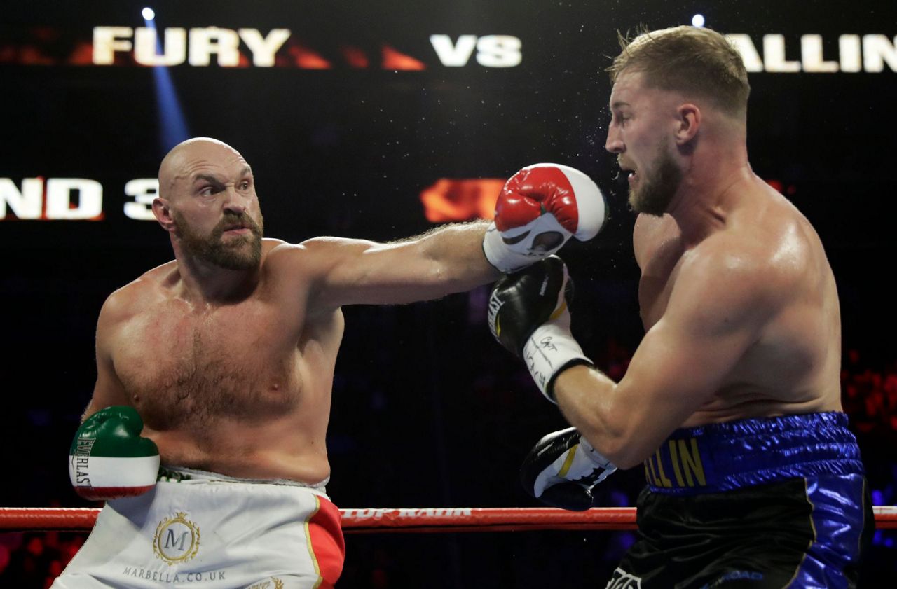 Fury overcomes bloody cut over eye to beat Wallin