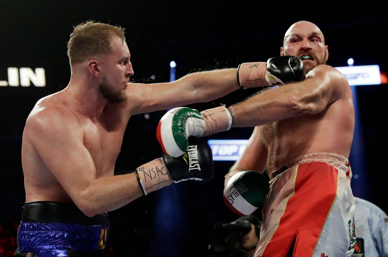 Fury overcomes bloody cut over eye to beat Wallin
