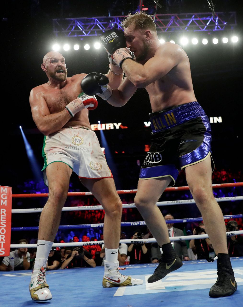 Fury overcomes bloody cut over eye to beat Wallin