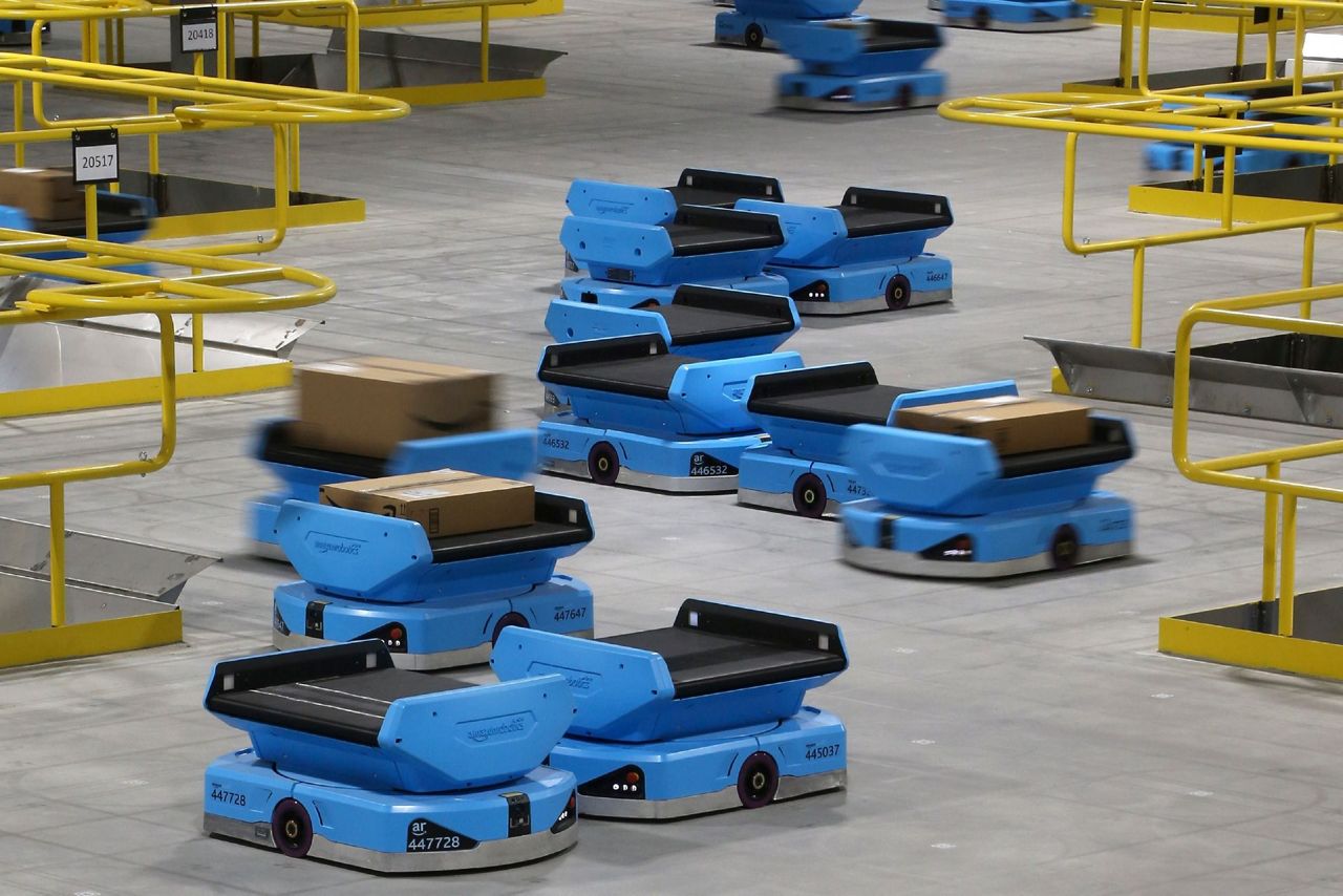 As robots take over warehousing, workers pushed to adapt