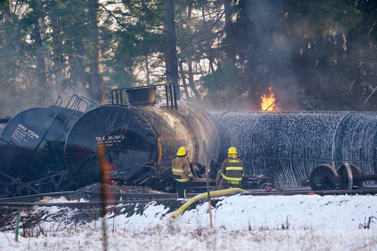Train cars carrying crude oil derail, burn north of Seattle