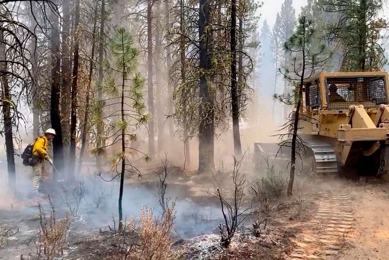 Dangerous conditions complicate wildfire fight in western US