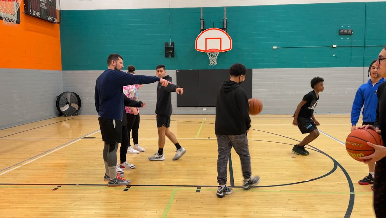 Police officers play basketball with kids to bridge gaps