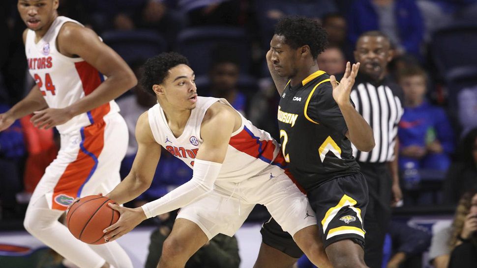 Lewis helps No. 15 Florida to tight win over Towson