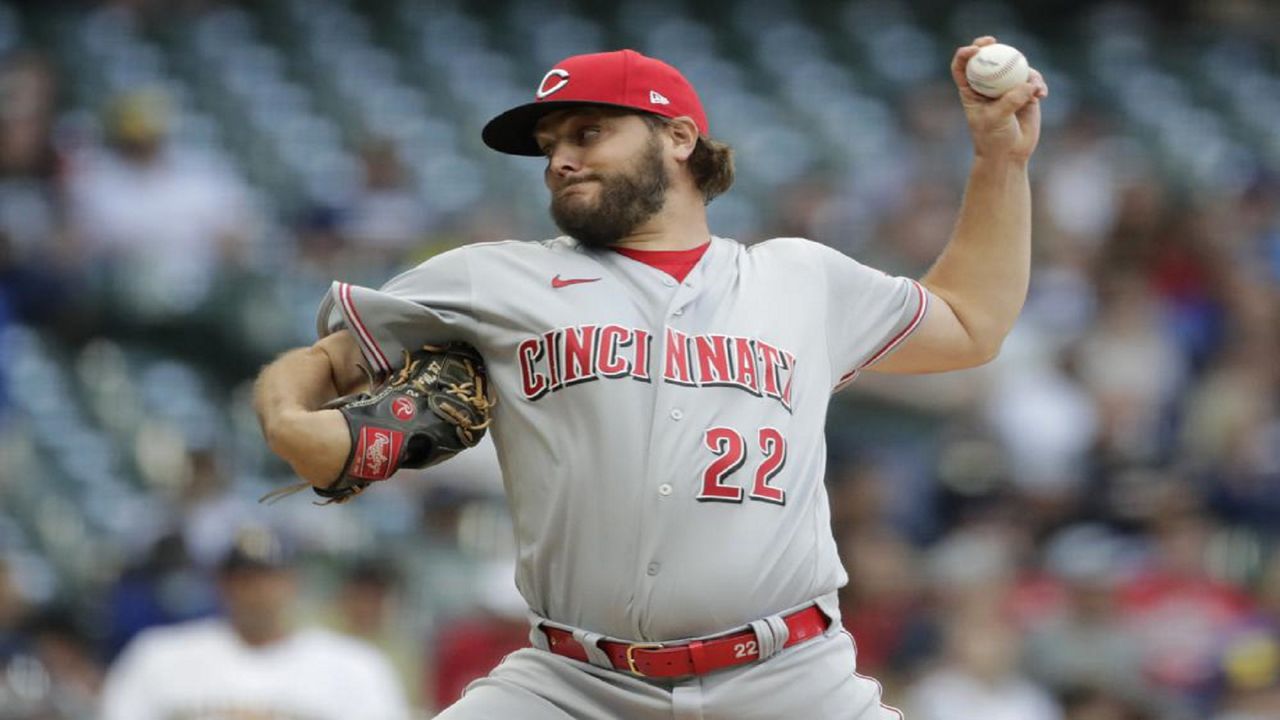 Miley delivers on mound and at plate as Reds top Brewers 2-0