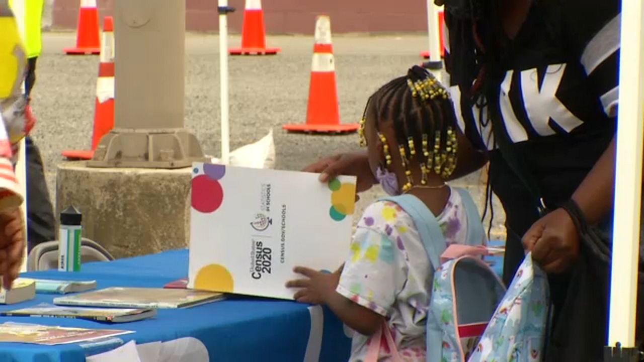 Dozens Complete Census Forms at City of Rochester Book Bag Giveaway
