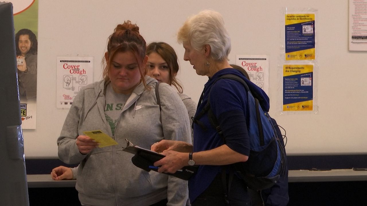 Retired teacher helps register voters at Milwaukee DMV