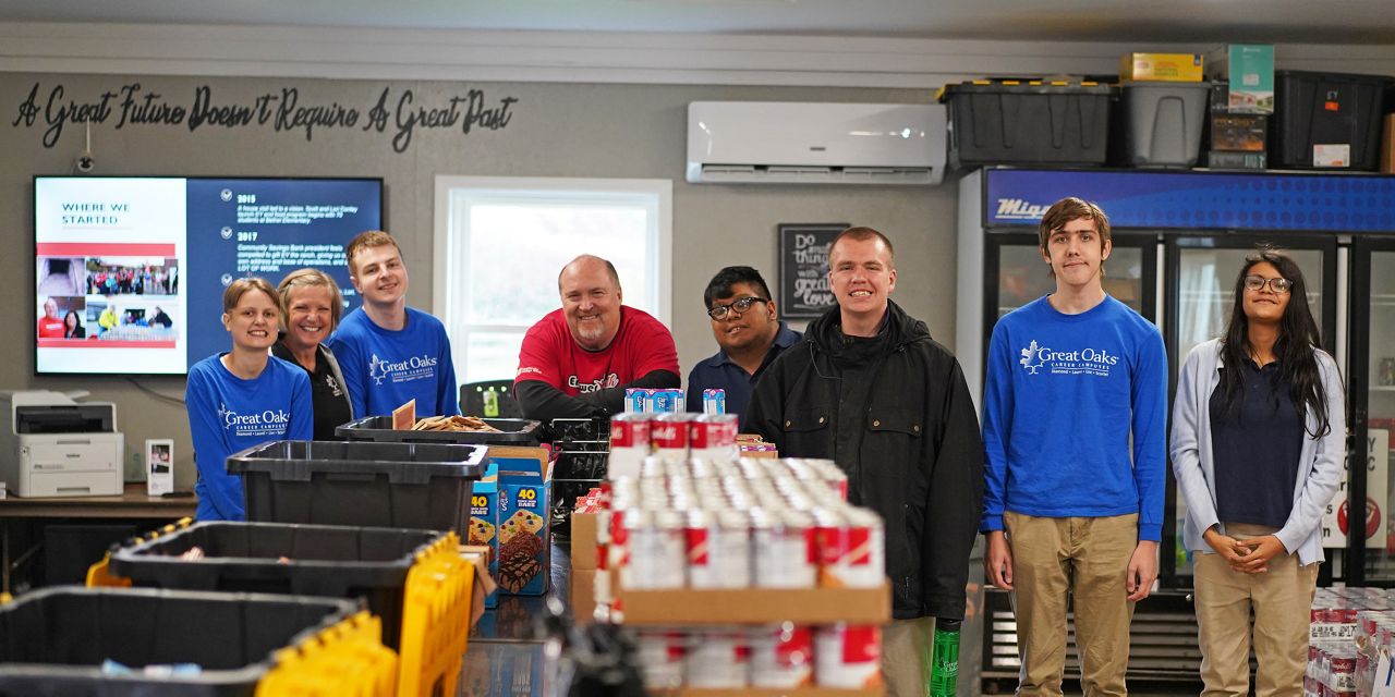 Students pack food bags for kids in need