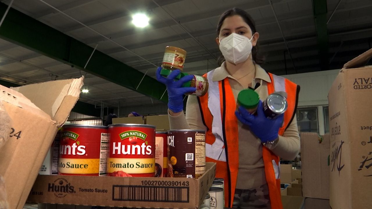 Feeding America volunteers pack 'Stuff the Bus' donations