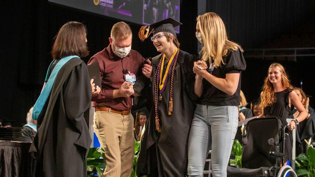 Grad crosses stage to get diploma one year after brain bleed