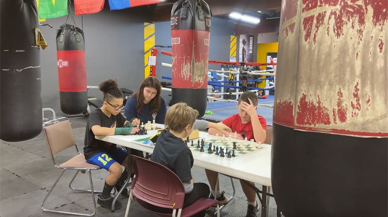 Brawn and brains, kids learn chess at boxing gym