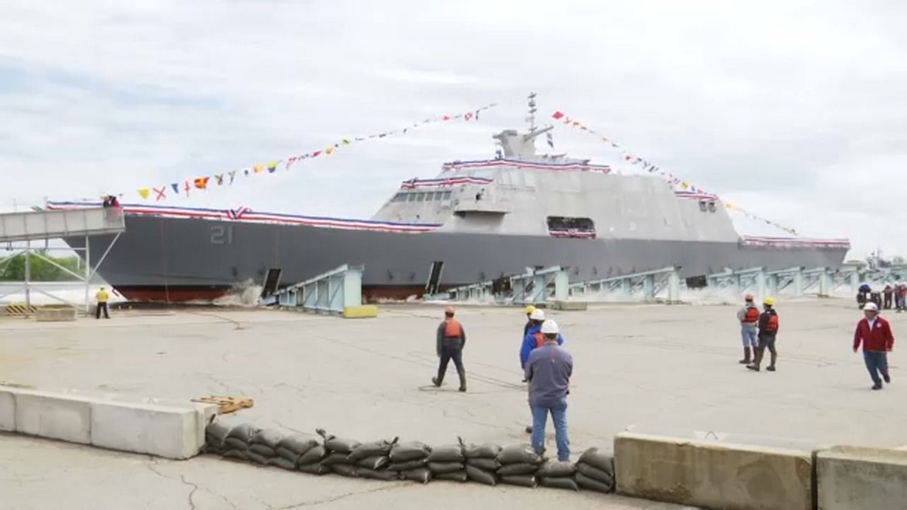 A future U.S. Navy ship launches to fanfare in the Menominee River