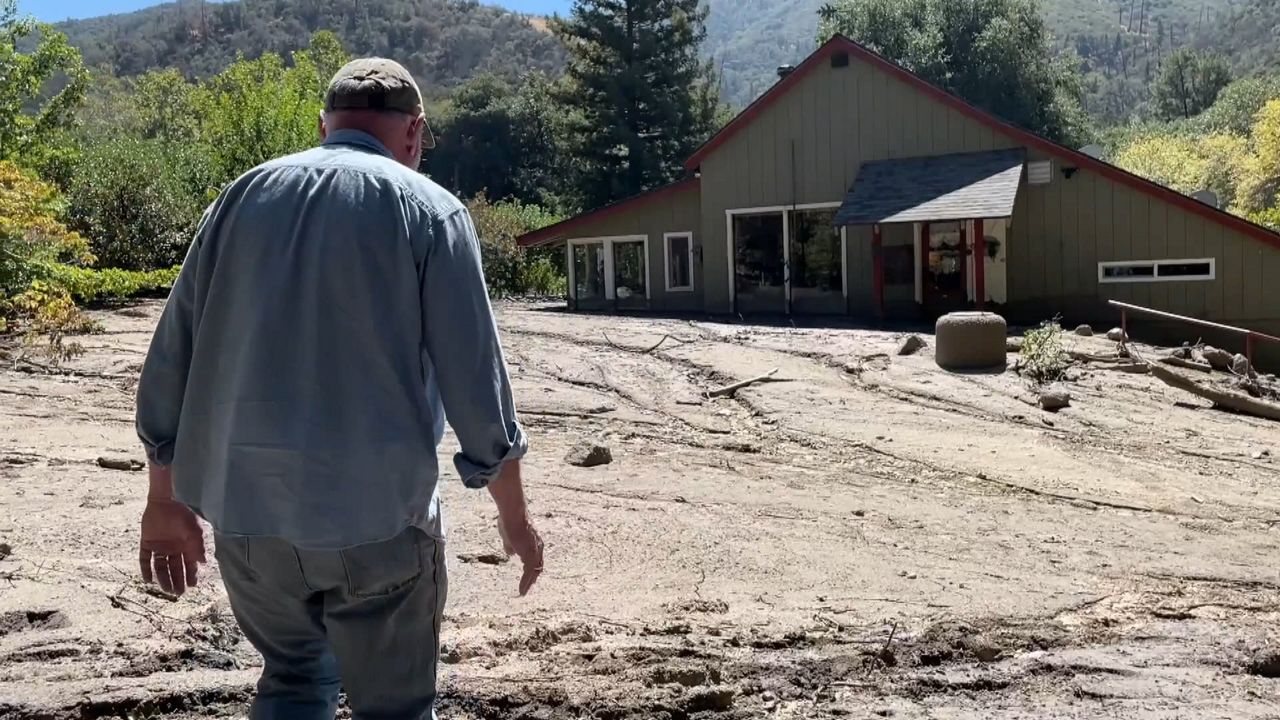 San Bernardino County resident assesses mudslide damage