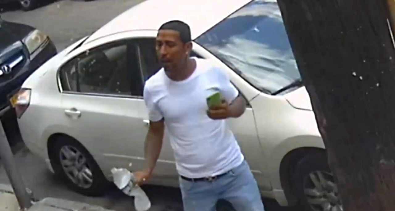 NYPD Seeks Man Who Sprayed Water on Two Queens Officers