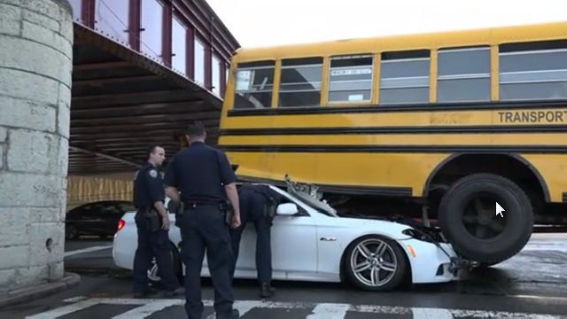 Car gets wedged under school bus in Queens