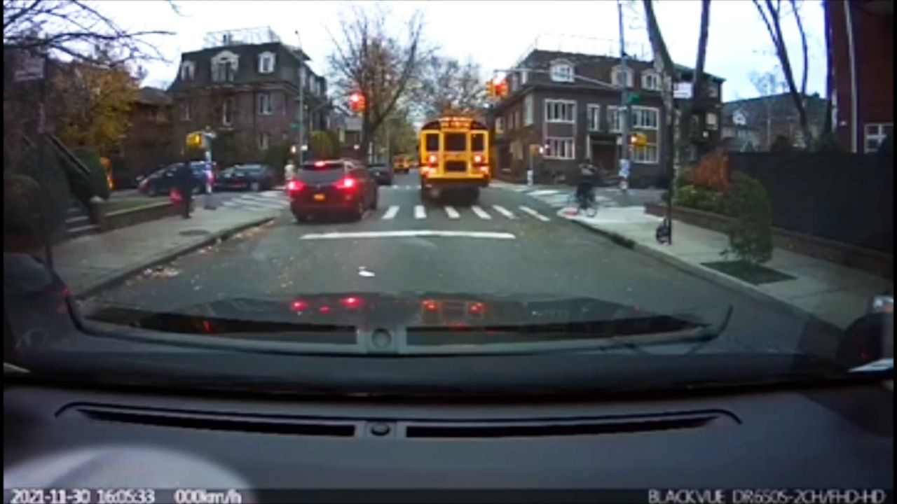 Dash cam video shows school buses running red lights