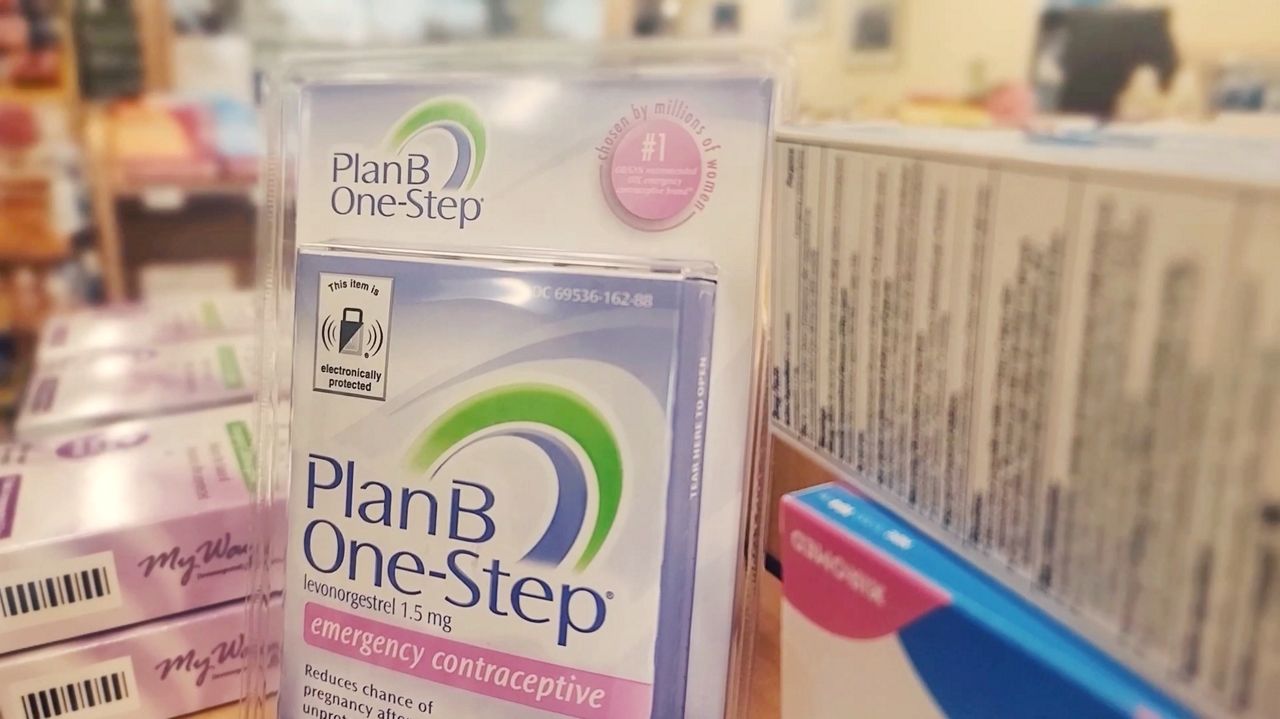 Pharmacist helping with contraceptive care options