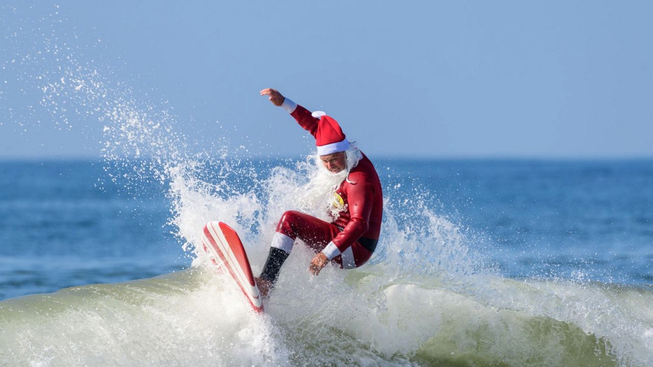 Witnesses spot Santa Claus surfing along LA-area beach