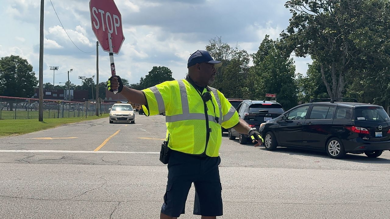 Traffic Guard handles influx of cars after busing changes