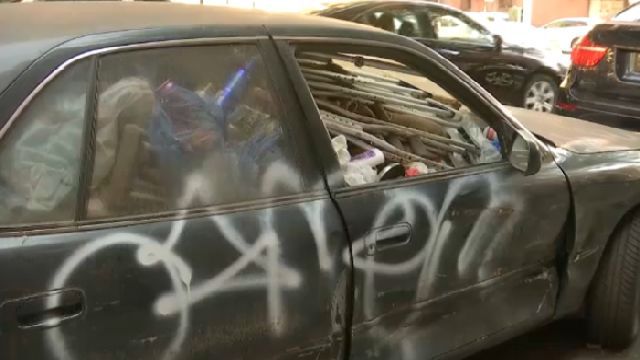 Trashy car filled to the brim removed from Park Slope street