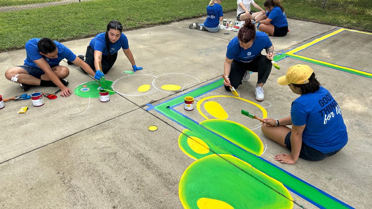 Volunteers beautify playground at St. Vincent de Paul